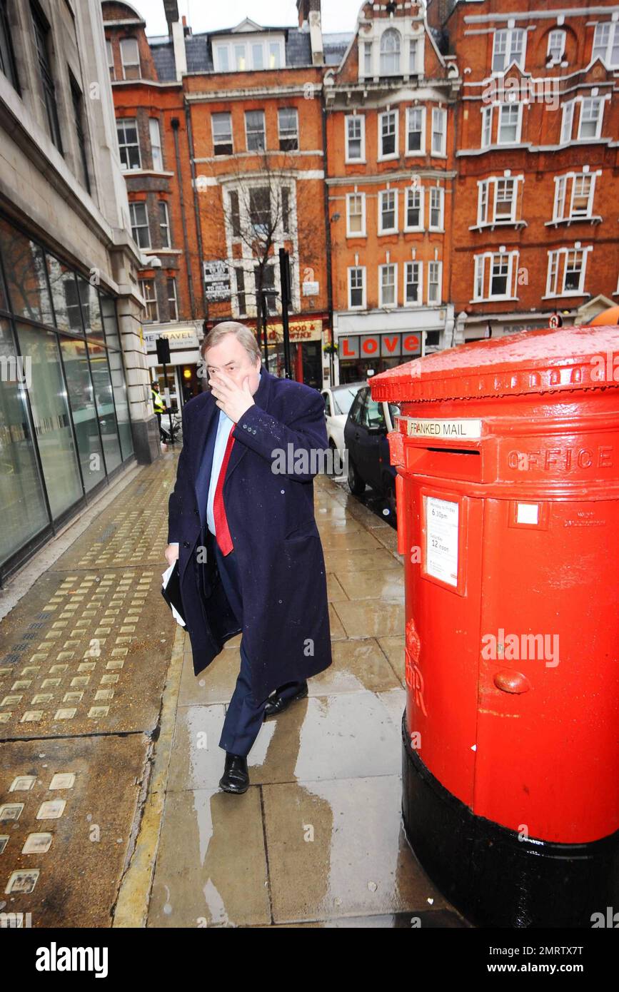 Lord John Prescott appears to grimace and scratch his face as he ...