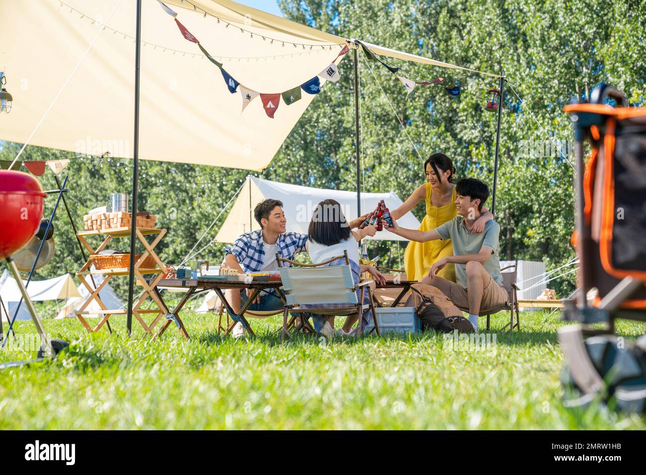 A group of people sat under the awning Stock Photo - Alamy