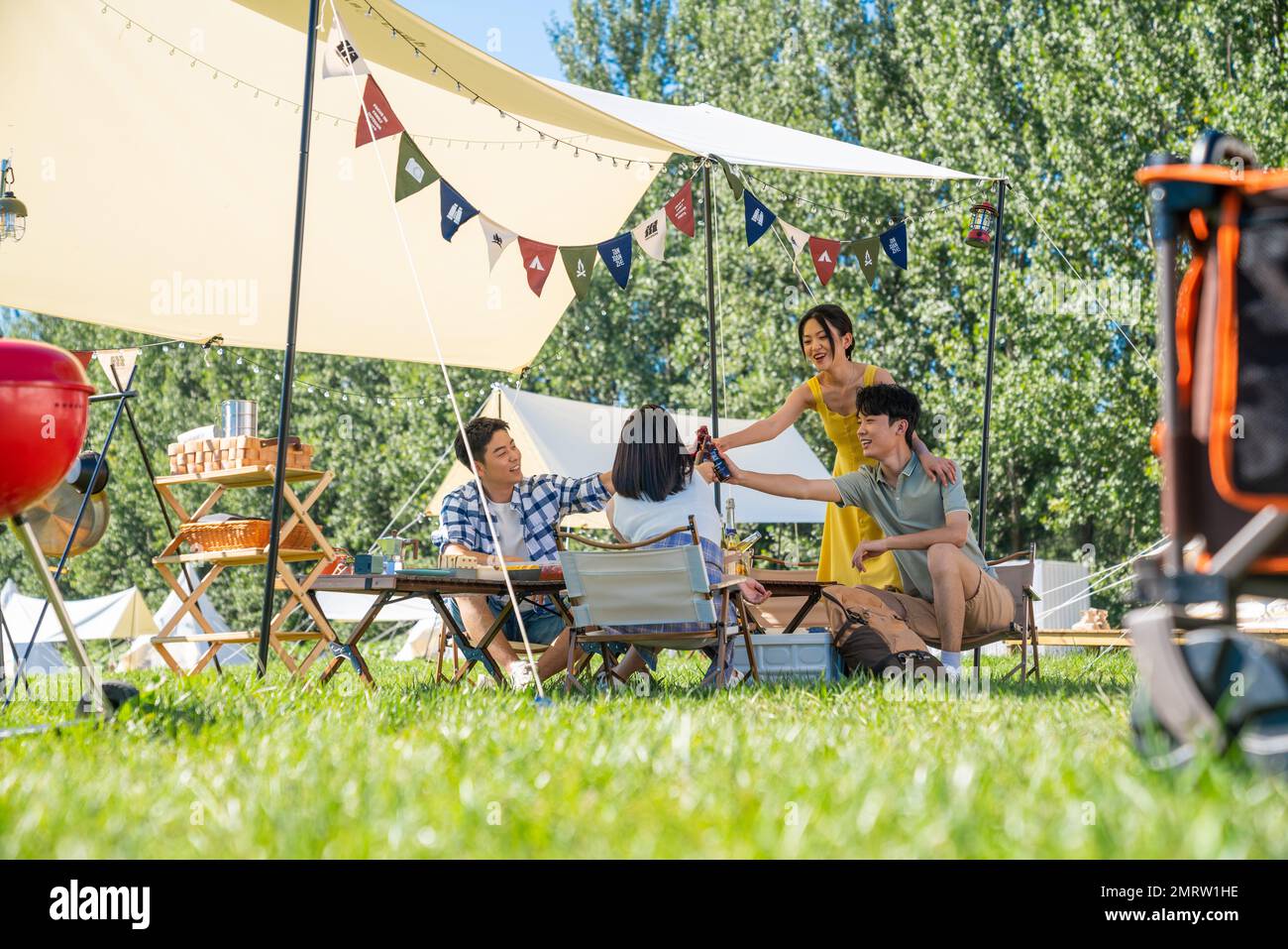 A group of people sat under the awning Stock Photo - Alamy