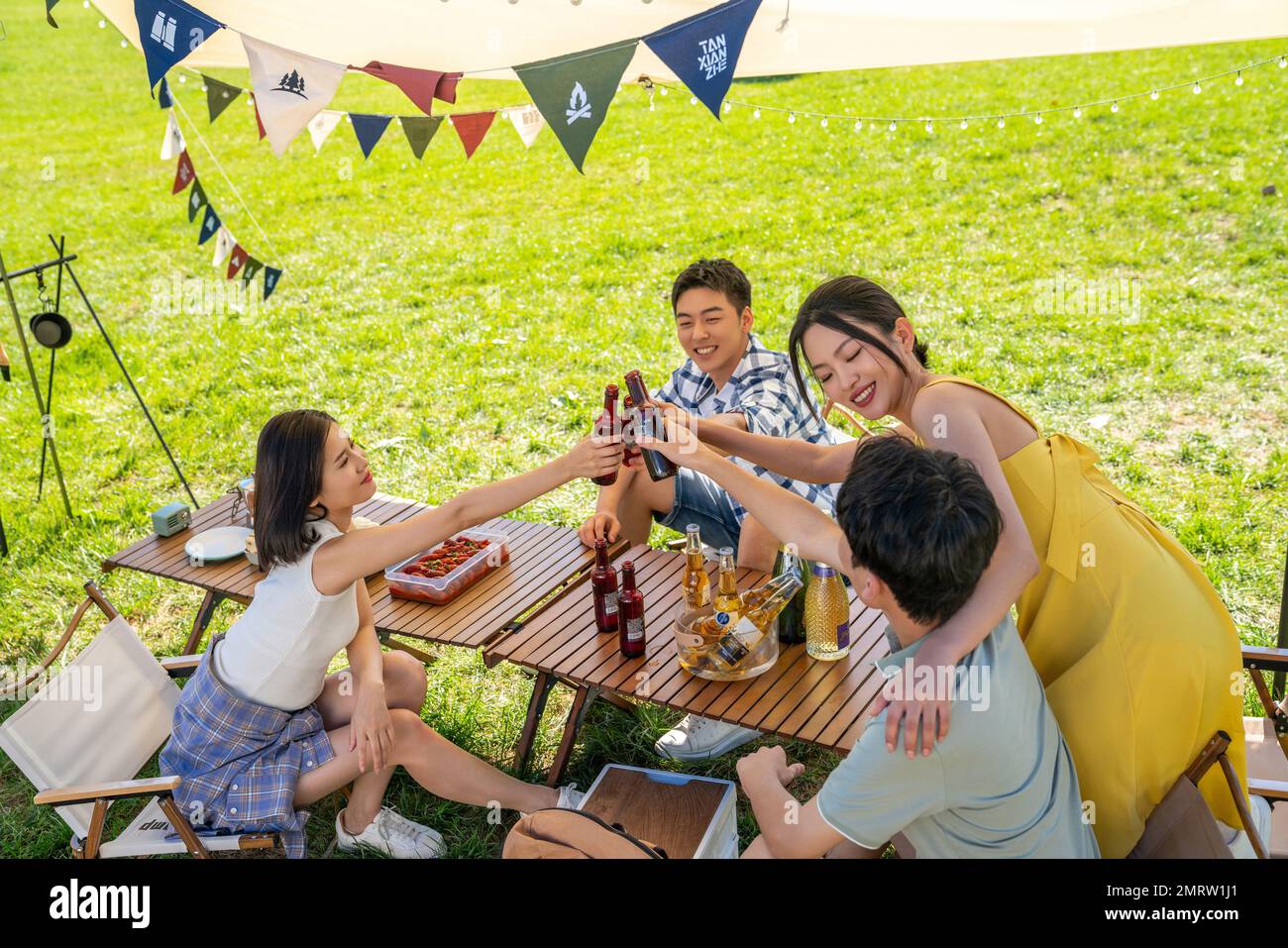 A group of people sat under the awning Stock Photo - Alamy