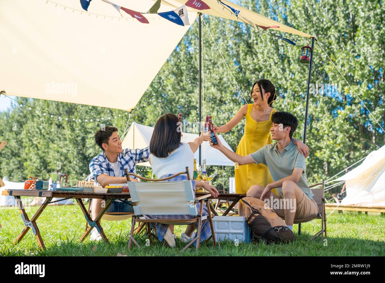 A group of people sat under the awning Stock Photo - Alamy