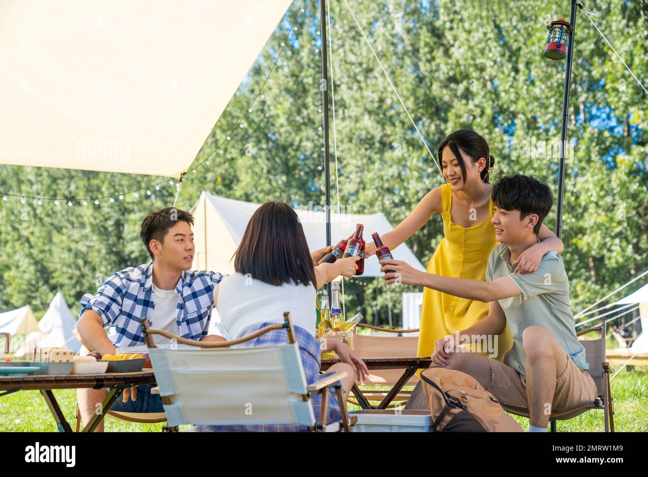 A group of people sat under the awning Stock Photo - Alamy