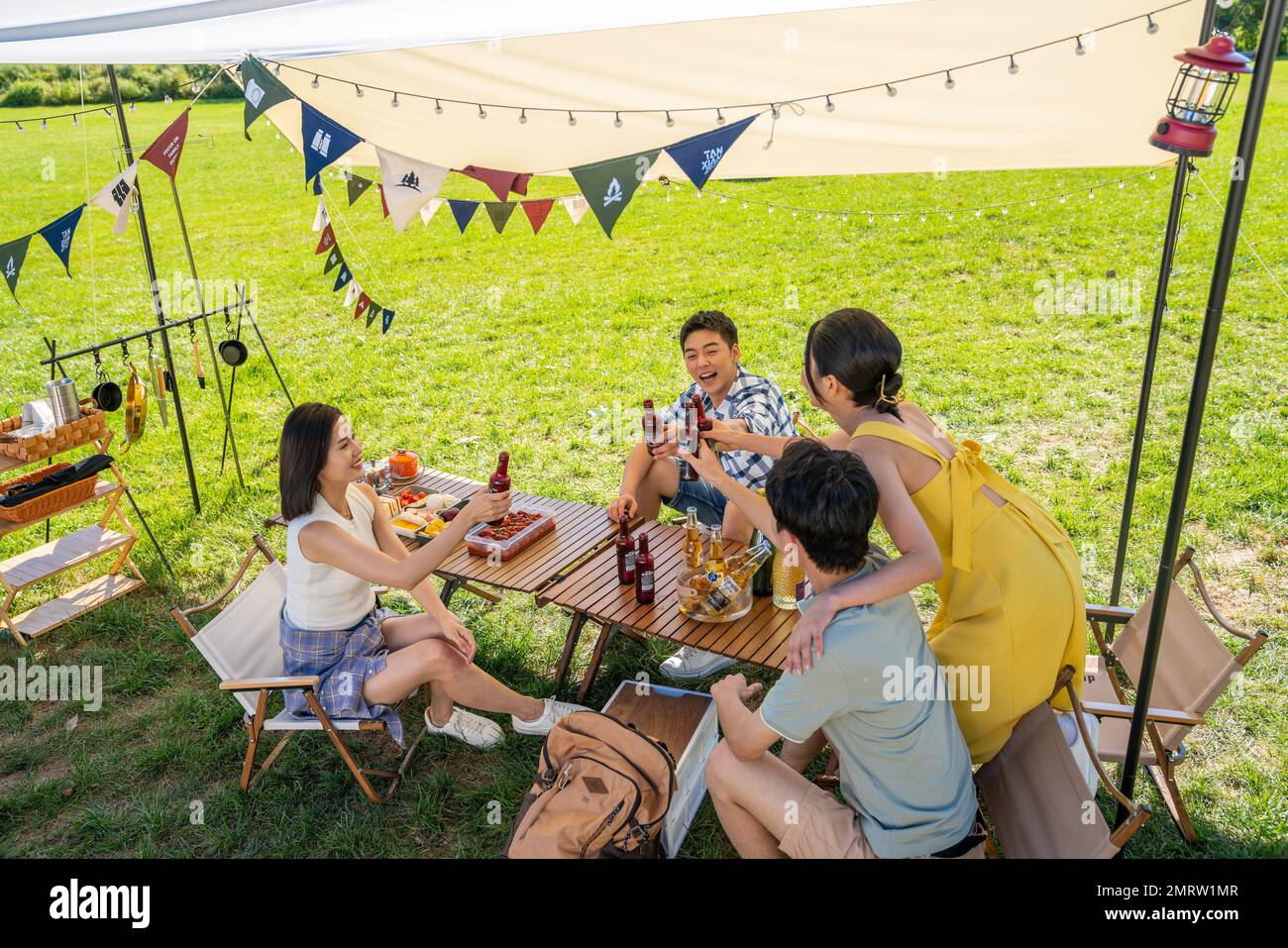 A group of people sat under the awning Stock Photo - Alamy