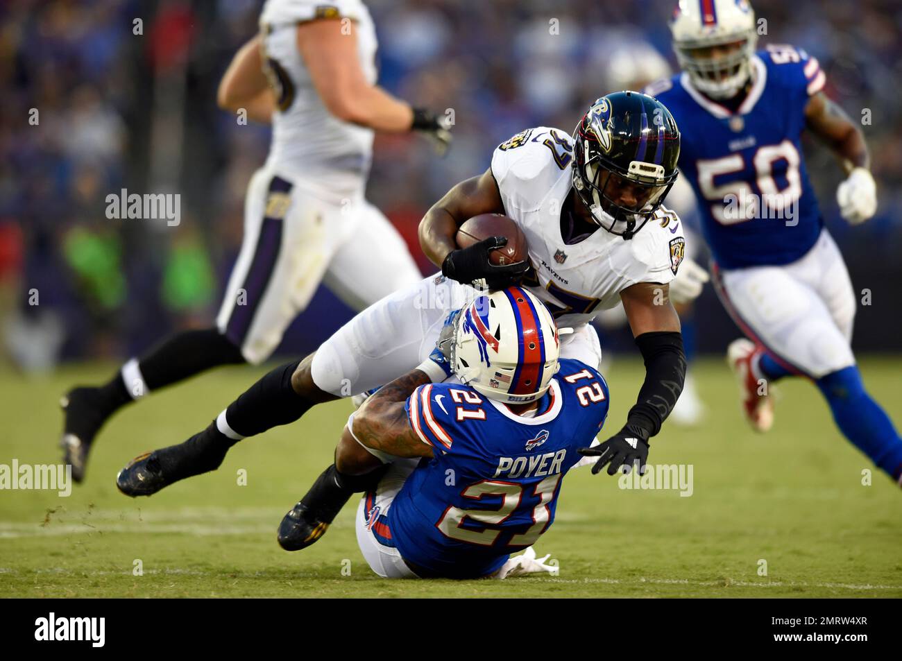 Baltimore Ravens running back Javorius Allen, top, is tackled by ...