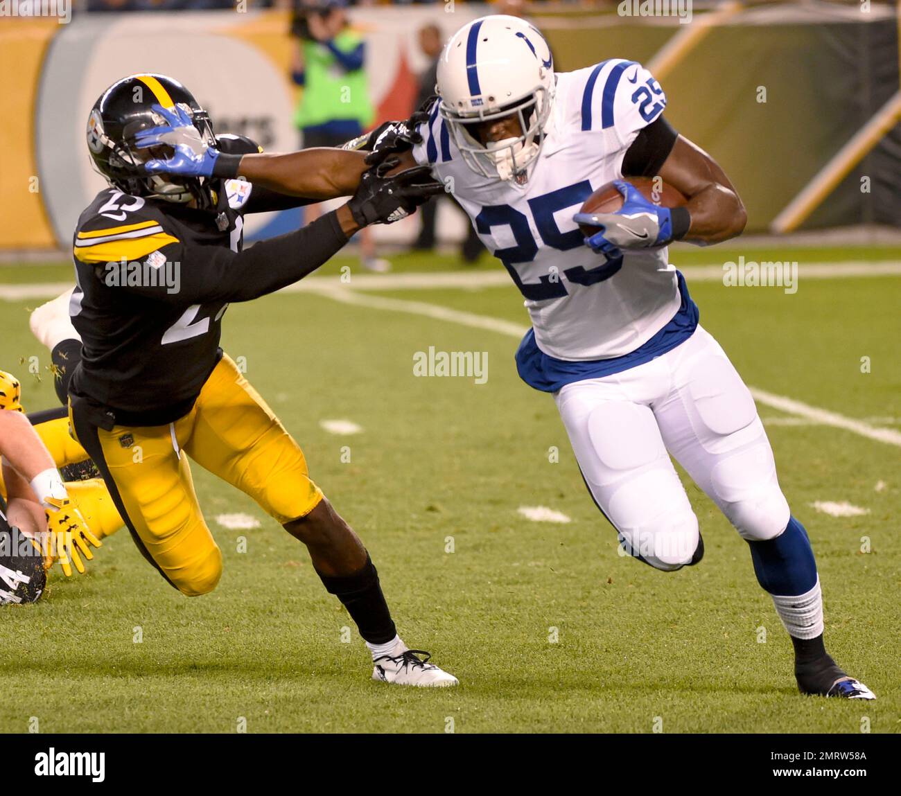 Indianapolis Colts running back Marlon Mack, right, stiff-arms ...