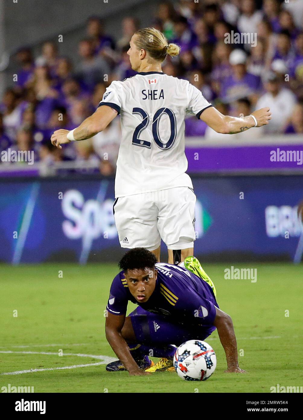 Orlando City 's Cristian Higuita, front, goes after the ball after Vancouver Whitecaps's Brek ...
