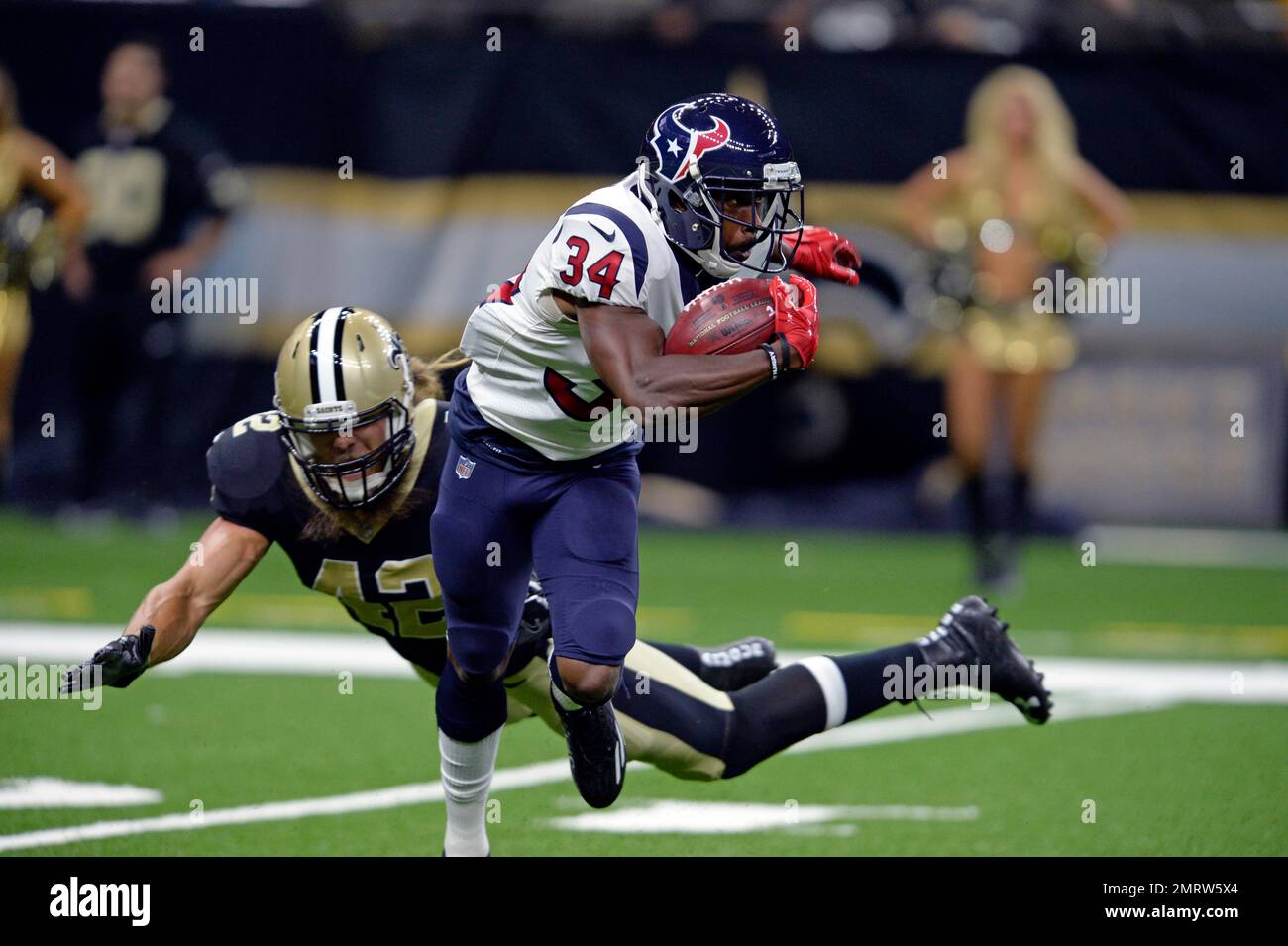 Houston Texans running back Tyler Ervin (34) rushes past New Orleans ...