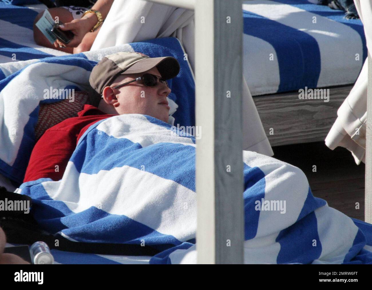 British comedic actor, Matt Lucas, lounges poolside wearing a matching ...