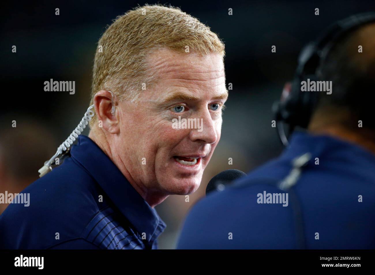 Dallas Cowboys head coach Jason Garrett talks to staff on the sideline ...