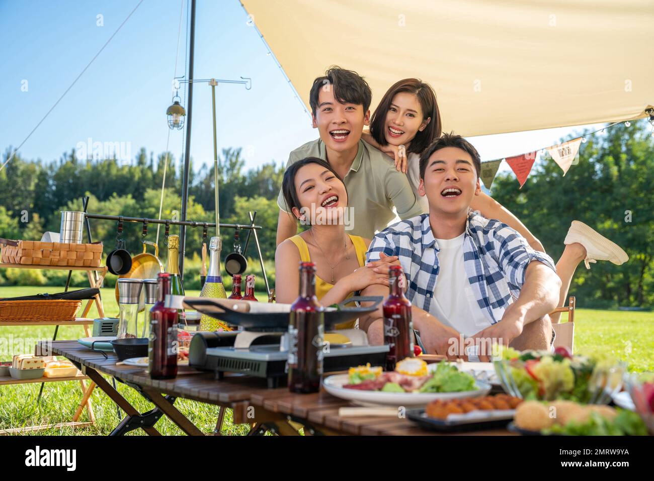 A group of people sat under the awning Stock Photo - Alamy