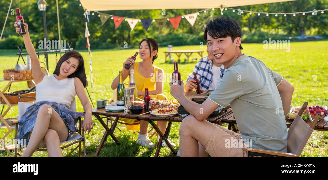 A group of people sat under the awning Stock Photo - Alamy