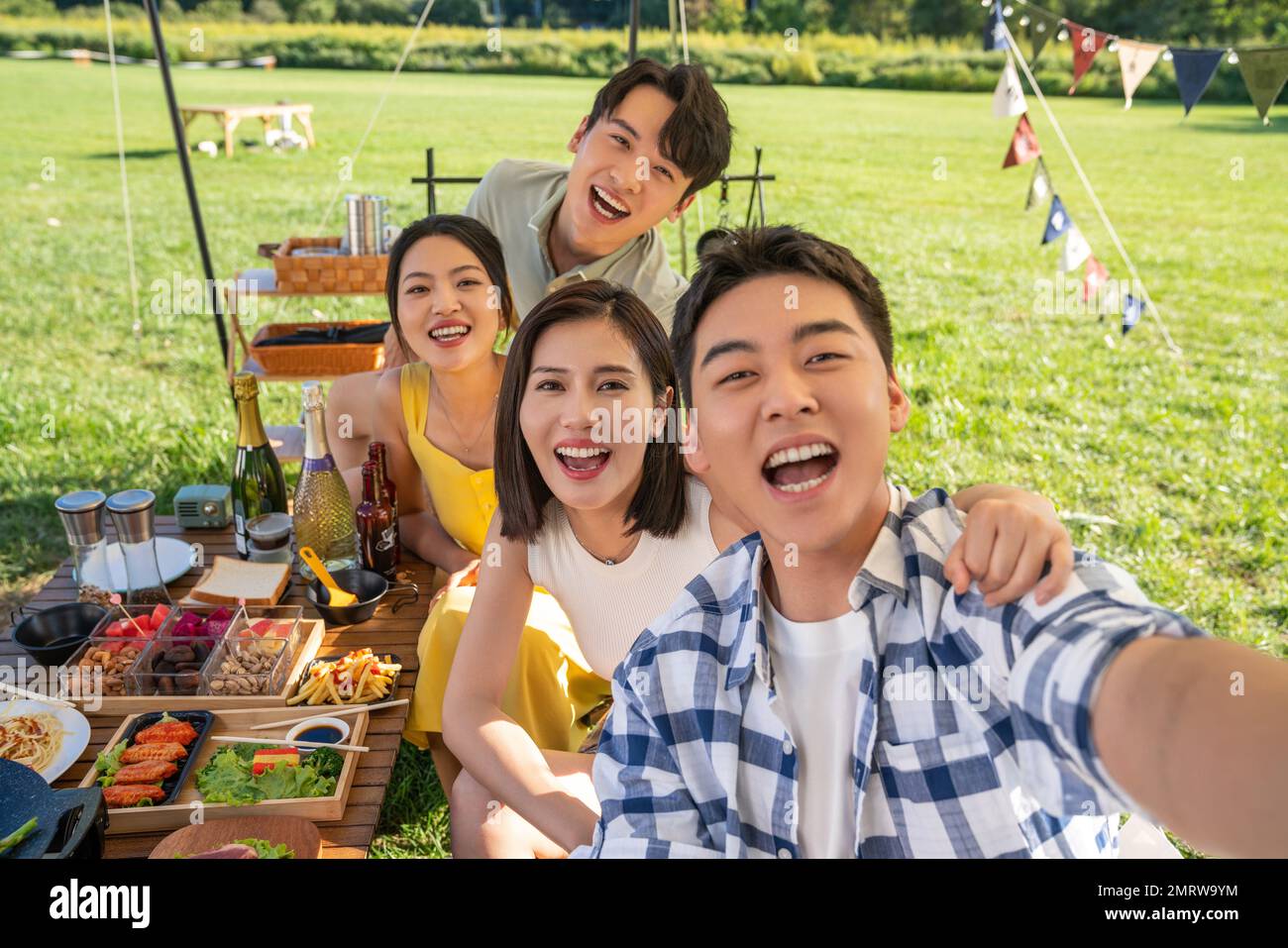 A group of people sat under the awning Stock Photo - Alamy