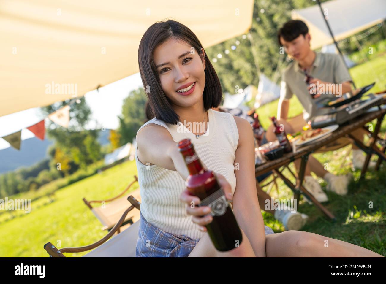 A group of people sat under the awning Stock Photo - Alamy
