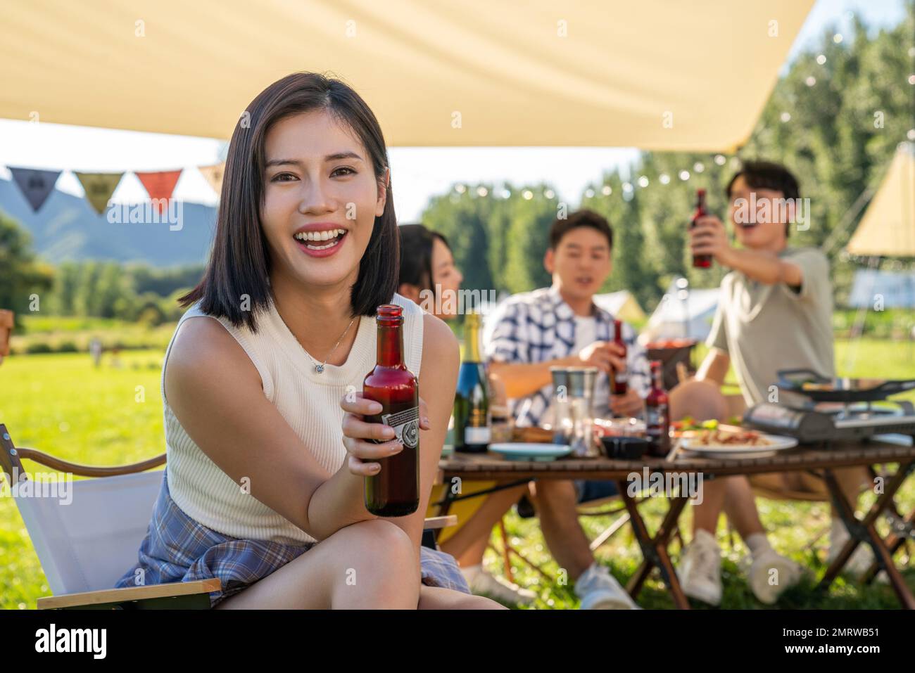 A group of people sat under the awning Stock Photo - Alamy