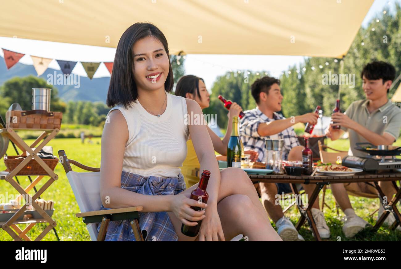 A group of people sat under the awning Stock Photo - Alamy