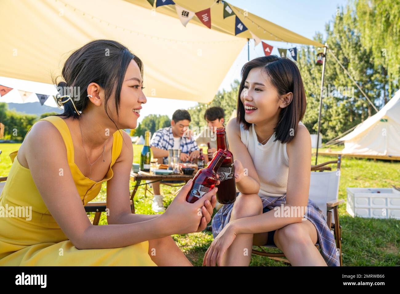 A group of people sat under the awning Stock Photo - Alamy