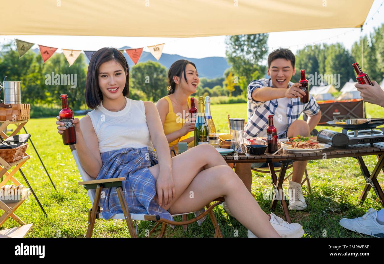 A group of people sat under the awning Stock Photo - Alamy