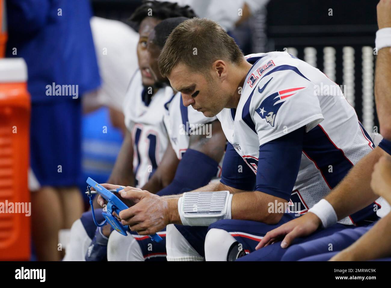 New England Patriots quarterback Tom Brady looks over a Microsoft ...