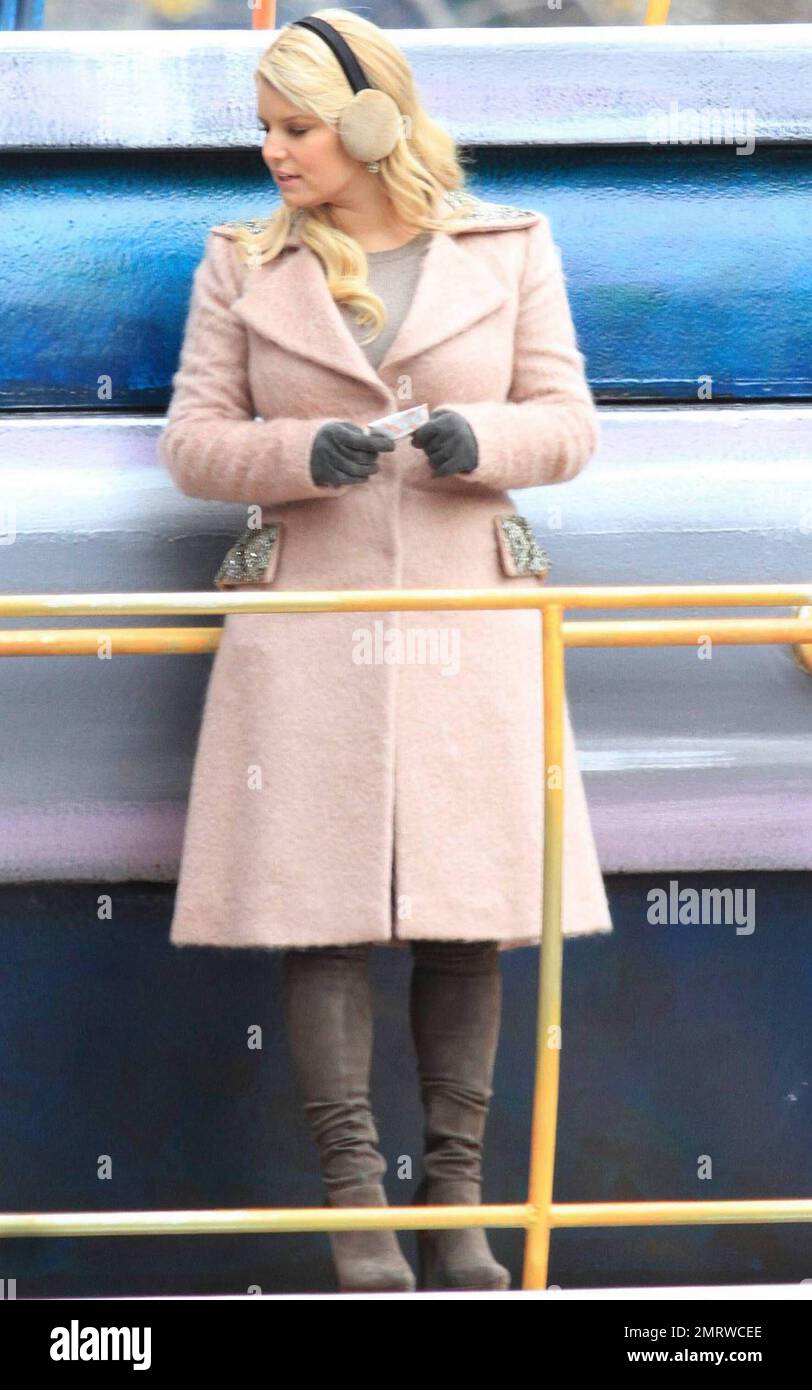 Wearing a pretty pink wool jacket, earmuffs and skintight boots ...