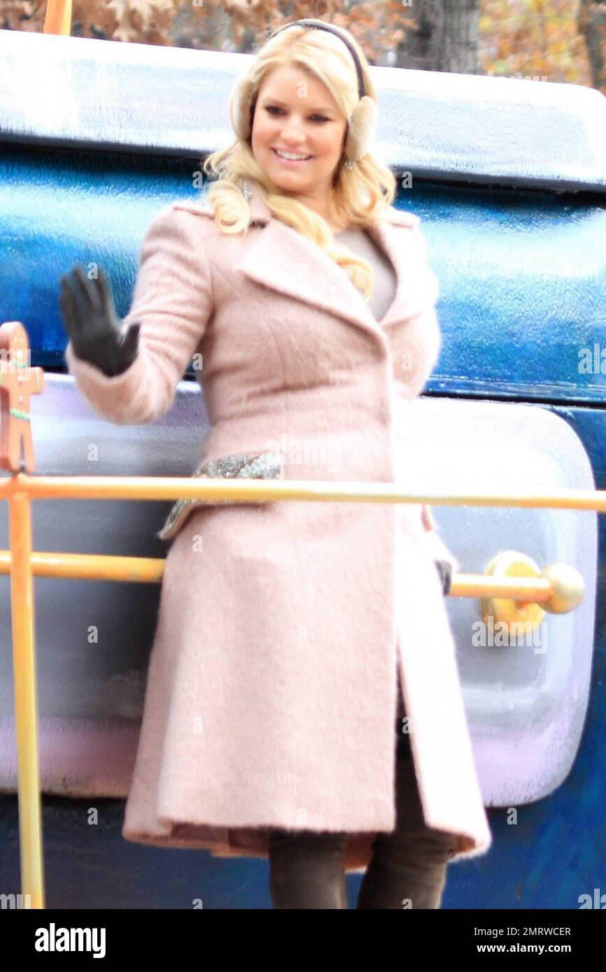 Wearing a pretty pink wool jacket, earmuffs and skintight boots ...