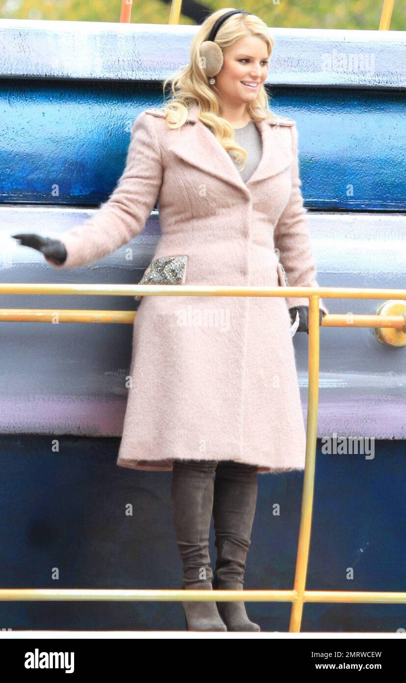 Wearing a pretty pink wool jacket, earmuffs and skintight boots ...