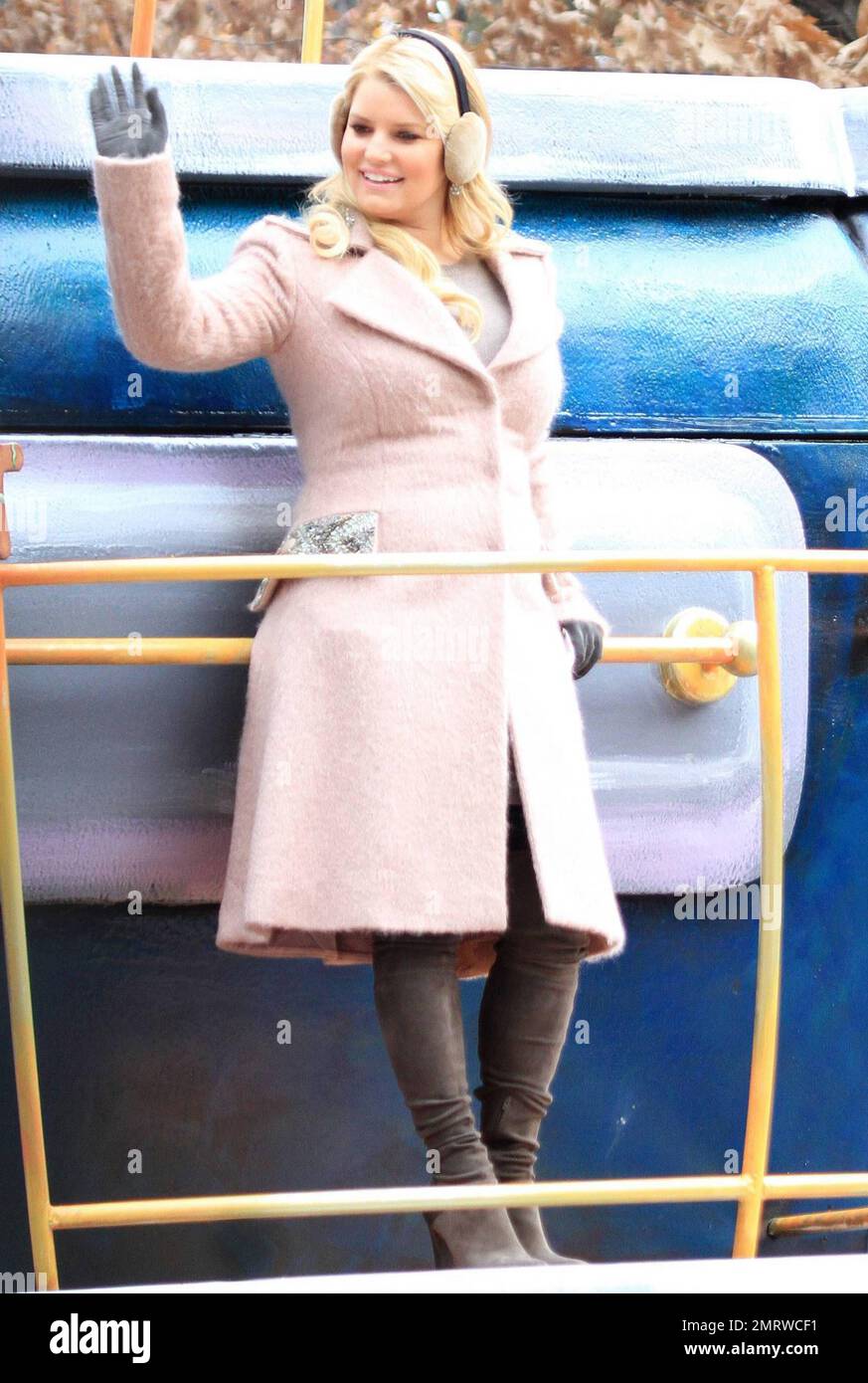 Wearing a pretty pink wool jacket, earmuffs and skintight boots ...