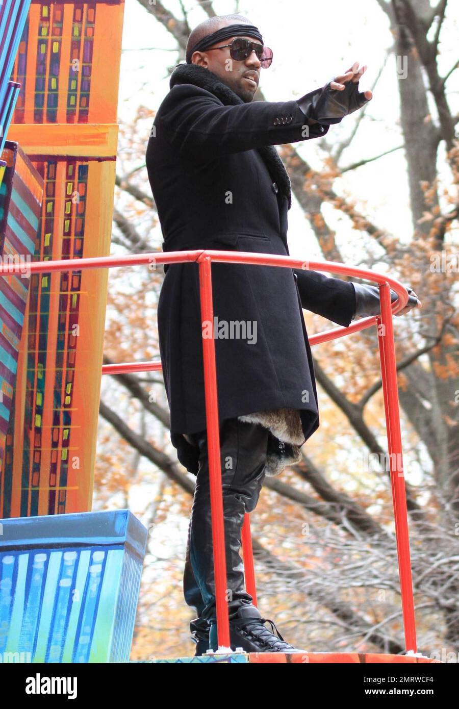 Clad in leather pants, headband, double-breasted wool coat and ...