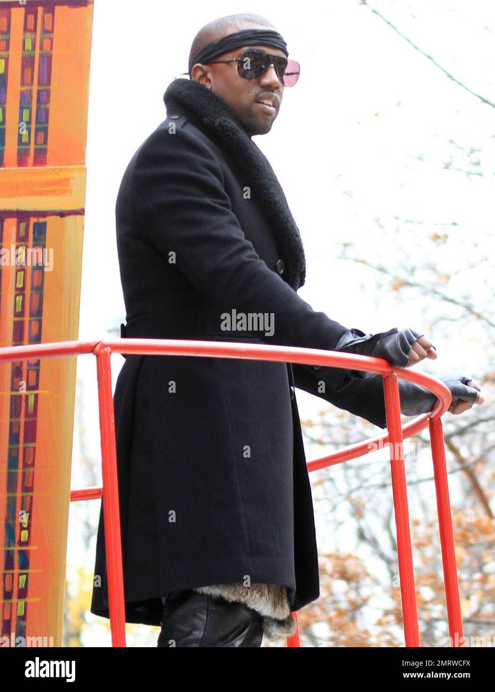 Clad in leather pants, headband, double-breasted wool coat and ...