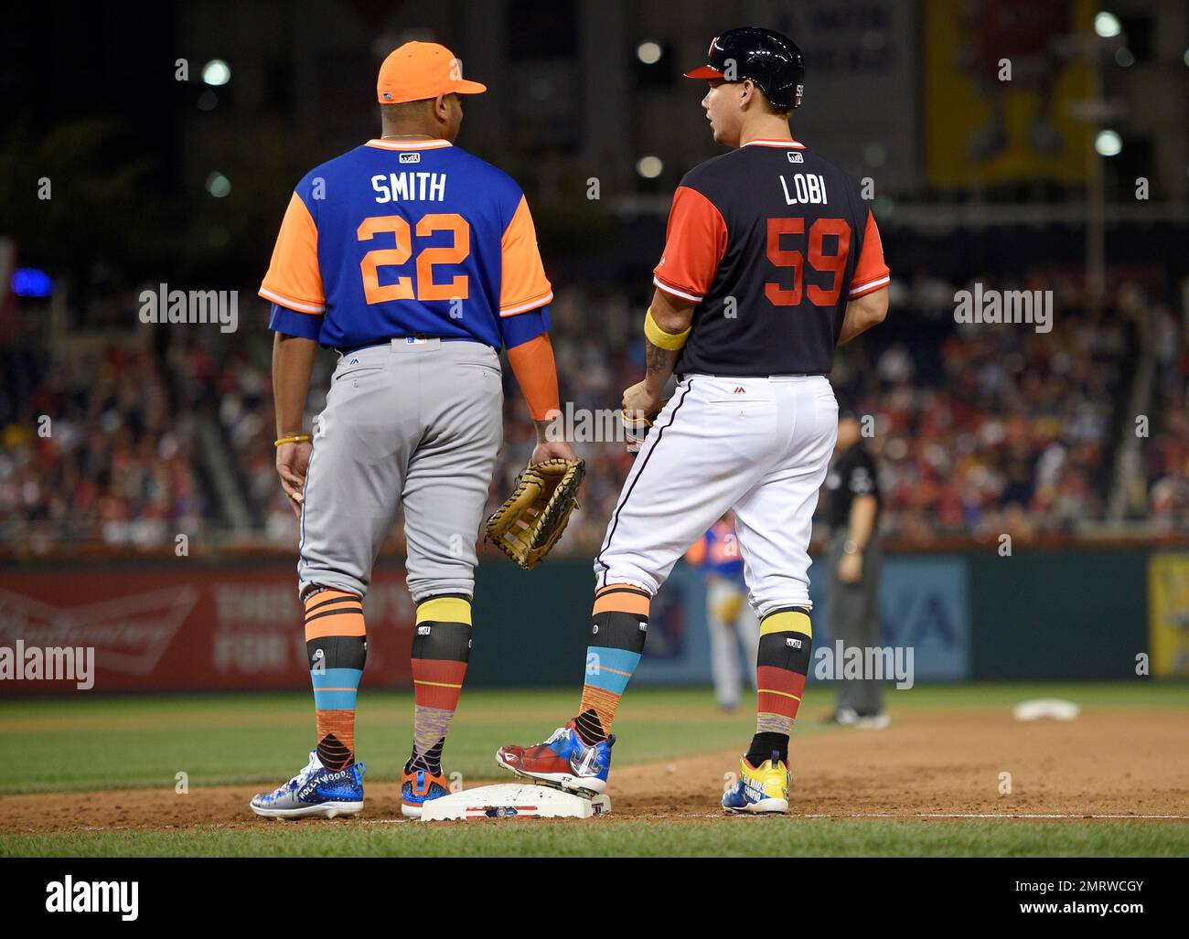 Washington Nationals' Jose Lobaton (59) stands next to New York Mets ...