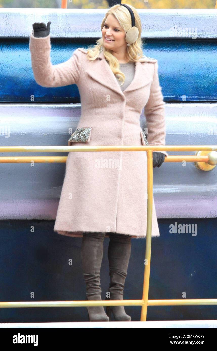 Wearing a pretty pink wool jacket, earmuffs and skintight boots ...