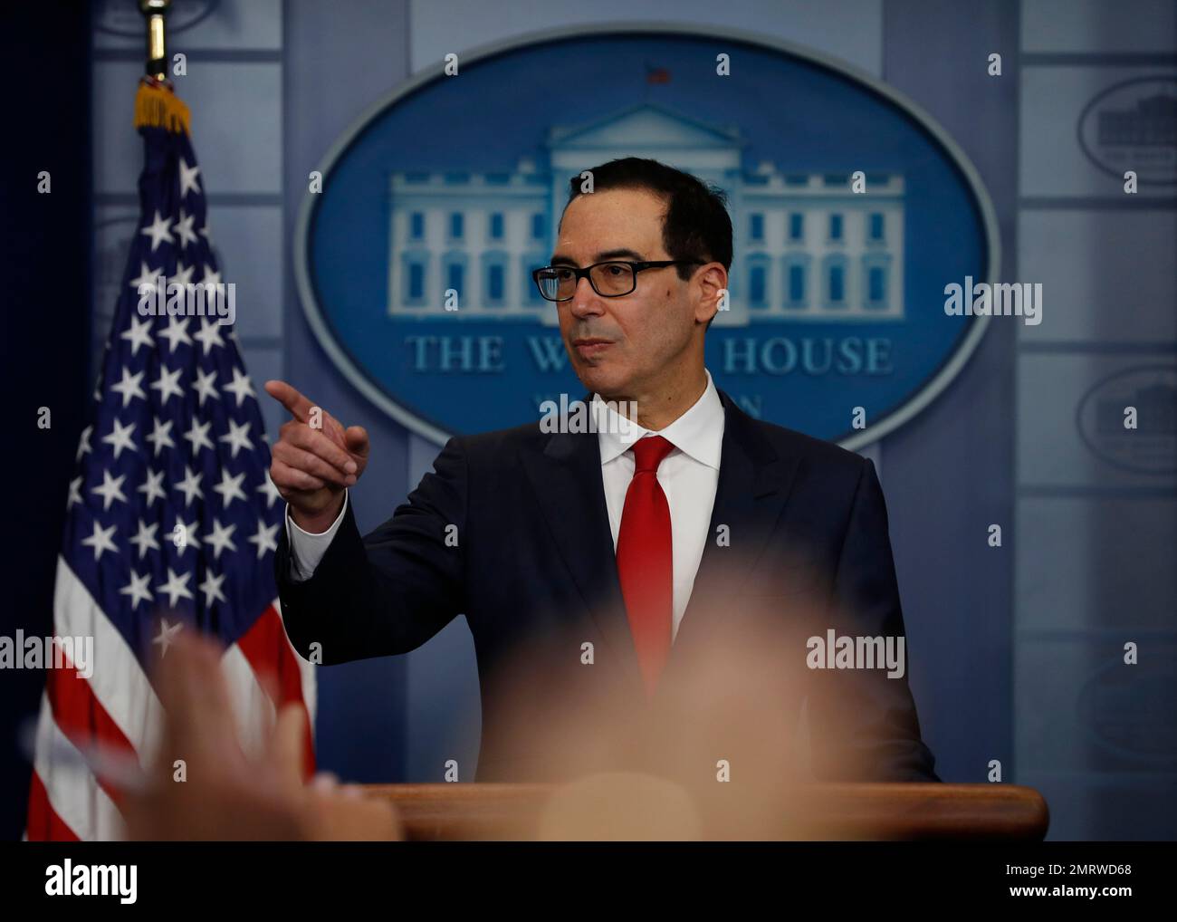 Treasury Secretary Steven Mnuchin points to a reporter to take a ...