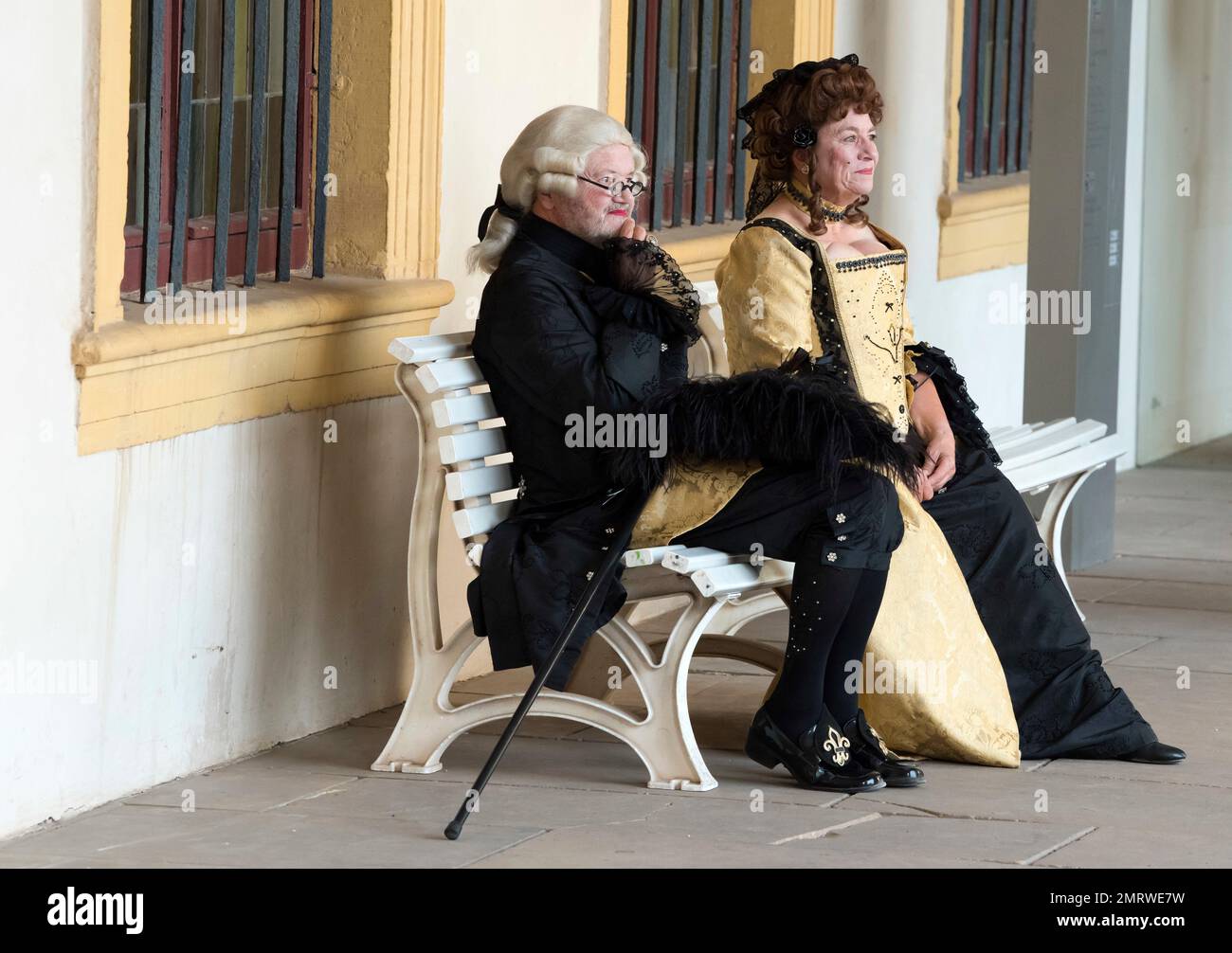 People dressed in Baroque costumes relax during the opening of the ...