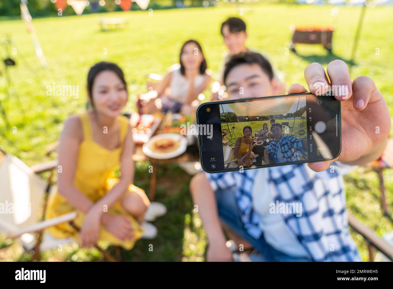 A group of people sat under the awning Stock Photo - Alamy