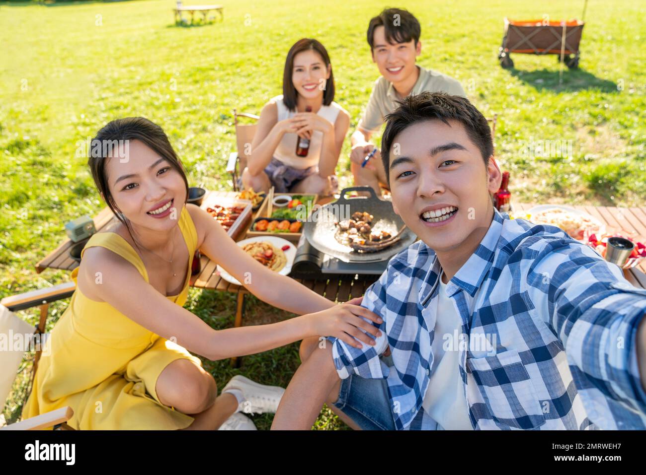 A group of people sat under the awning Stock Photo - Alamy