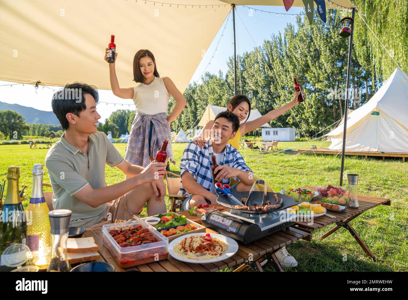A group of people sat under the awning Stock Photo - Alamy