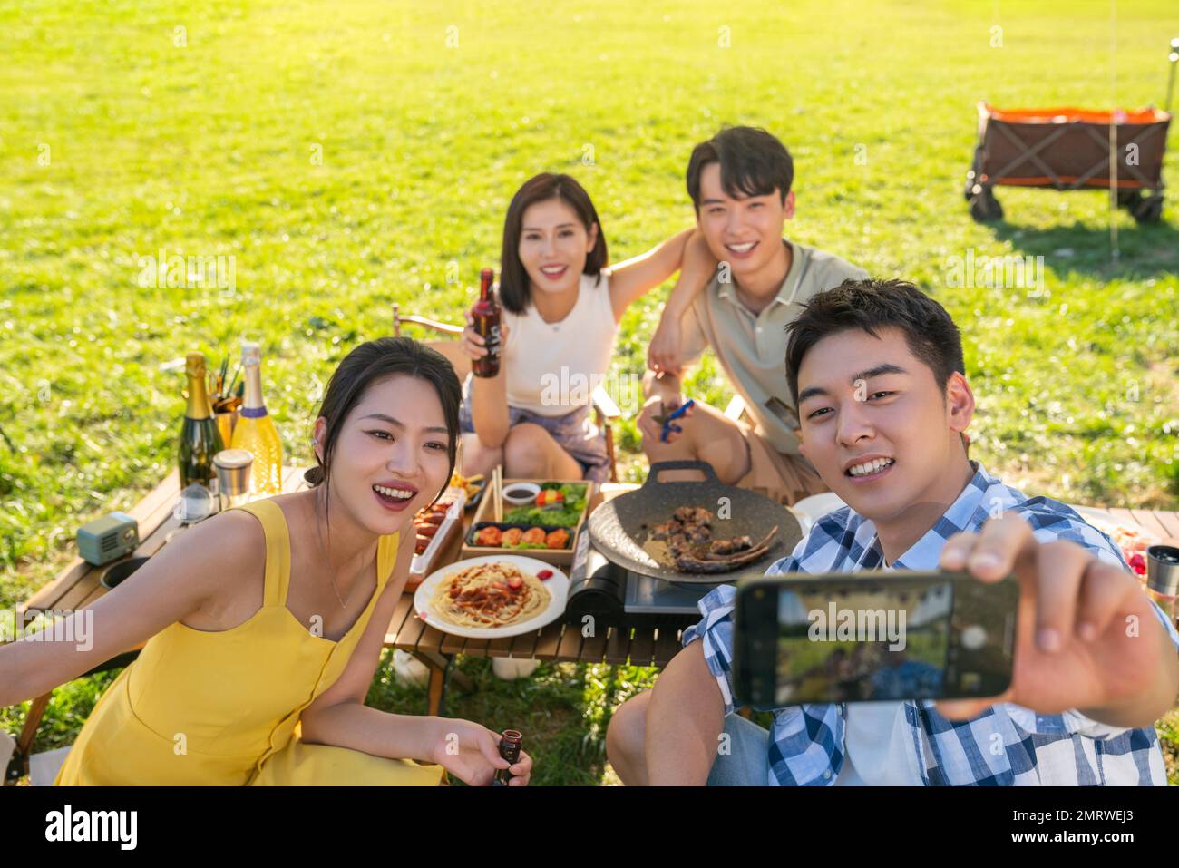 A group of people sat under the awning Stock Photo - Alamy