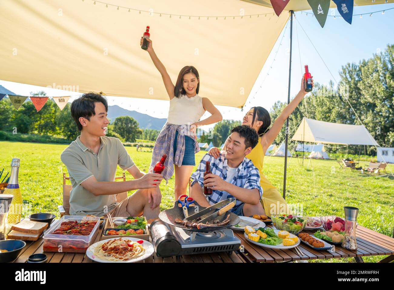 A group of people sat under the awning Stock Photo - Alamy