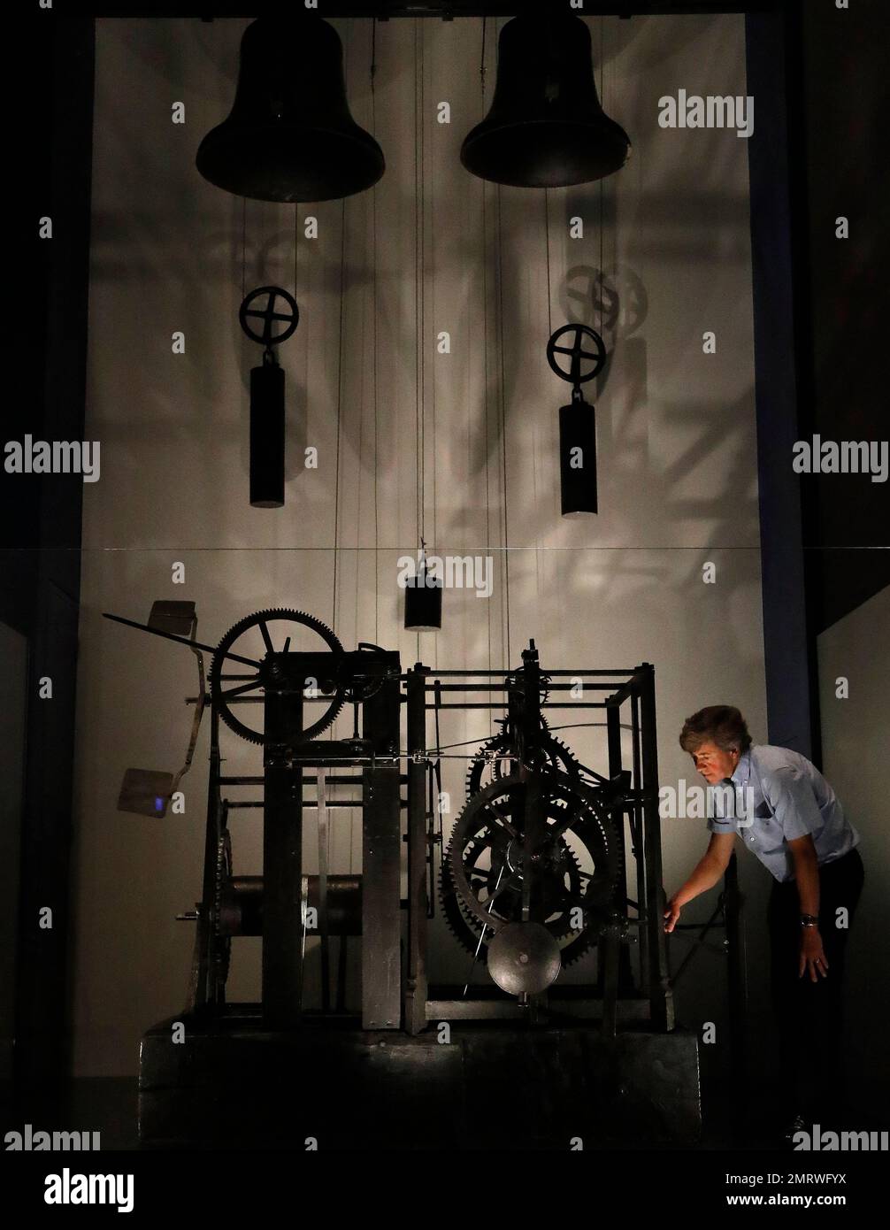 A museum employee checks the Wells Cathedral clock mechanism, on ...