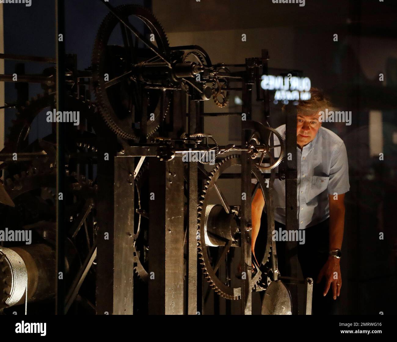 A museum employee checks the Wells Cathedral clock mechanism, on ...