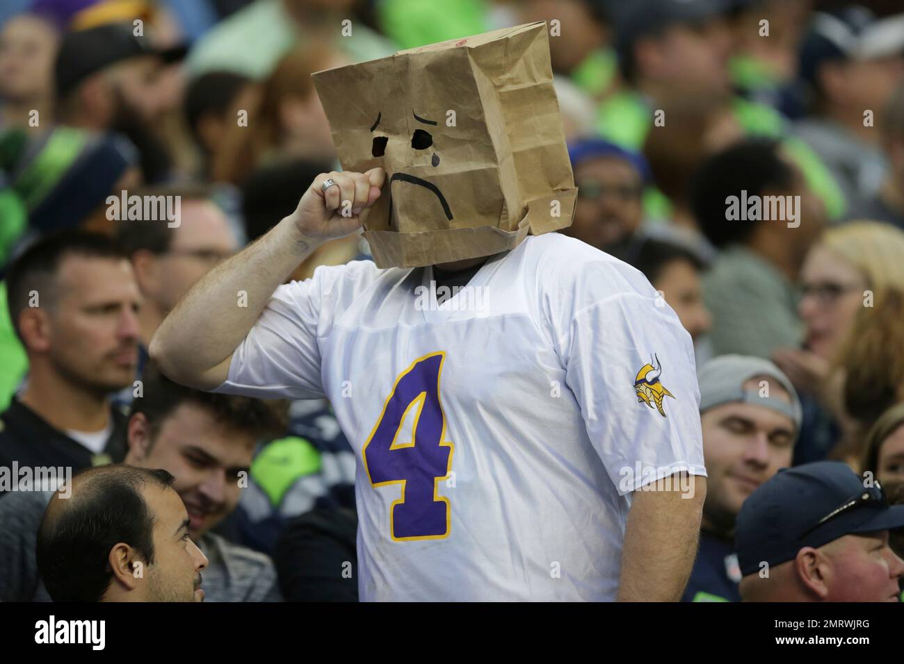 A fan wearing a Minnesota Vikings Brett Favre jersey wears a bag on his ...