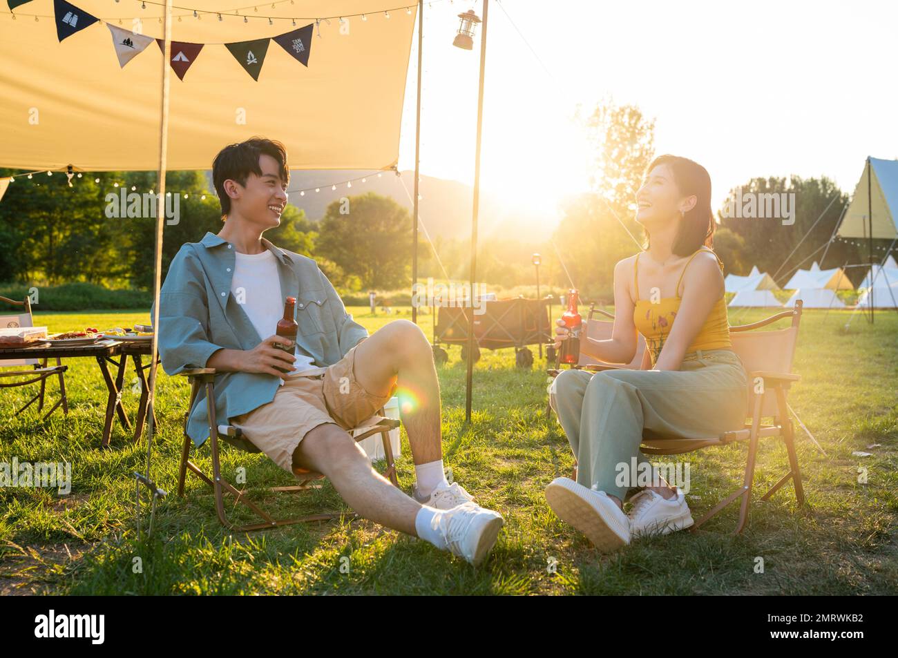 A group of people sat under the tent Stock Photo - Alamy