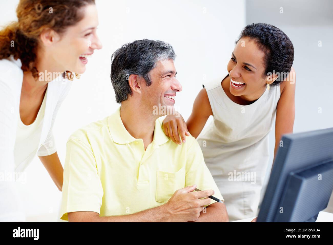 Executives smiling at work. Casually dressed executives looking at each ...