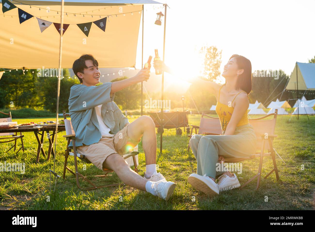 A group of people sat under the tent Stock Photo - Alamy
