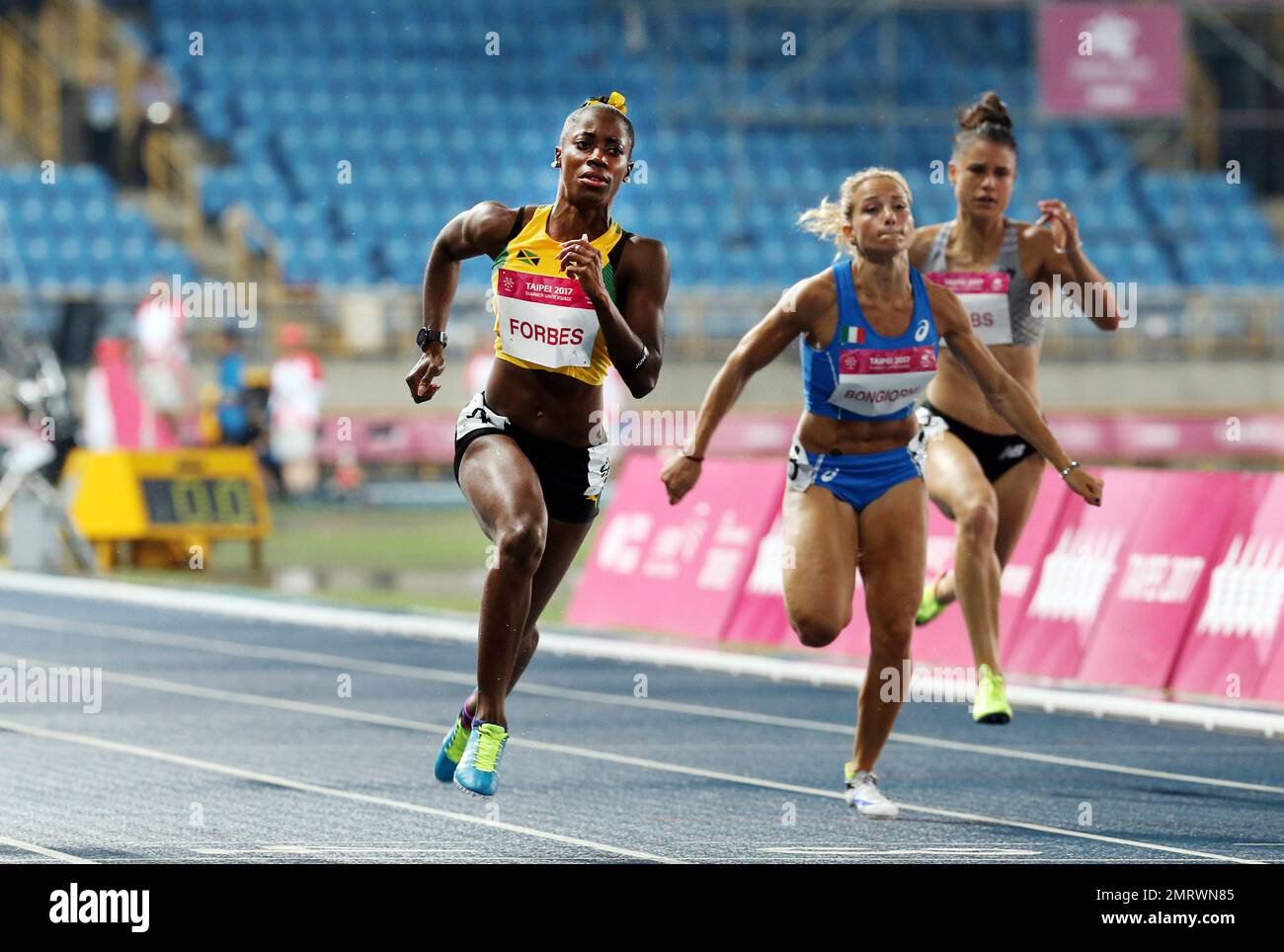 Jamaica's Sashalee Forbes, left, finishes a women's 100m semifinal ...