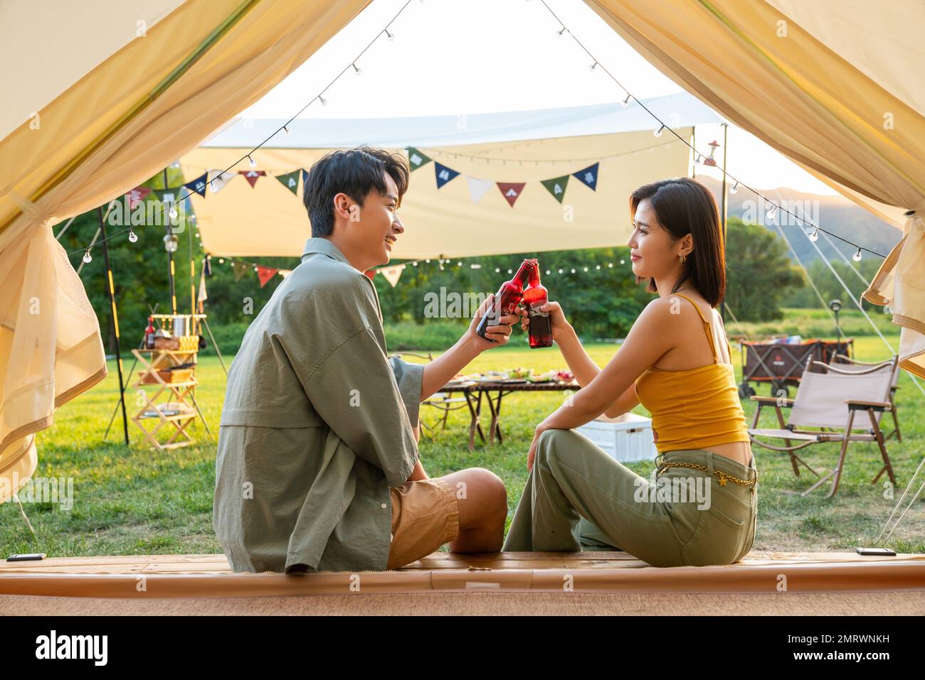 A group of people sat under the tent Stock Photo - Alamy