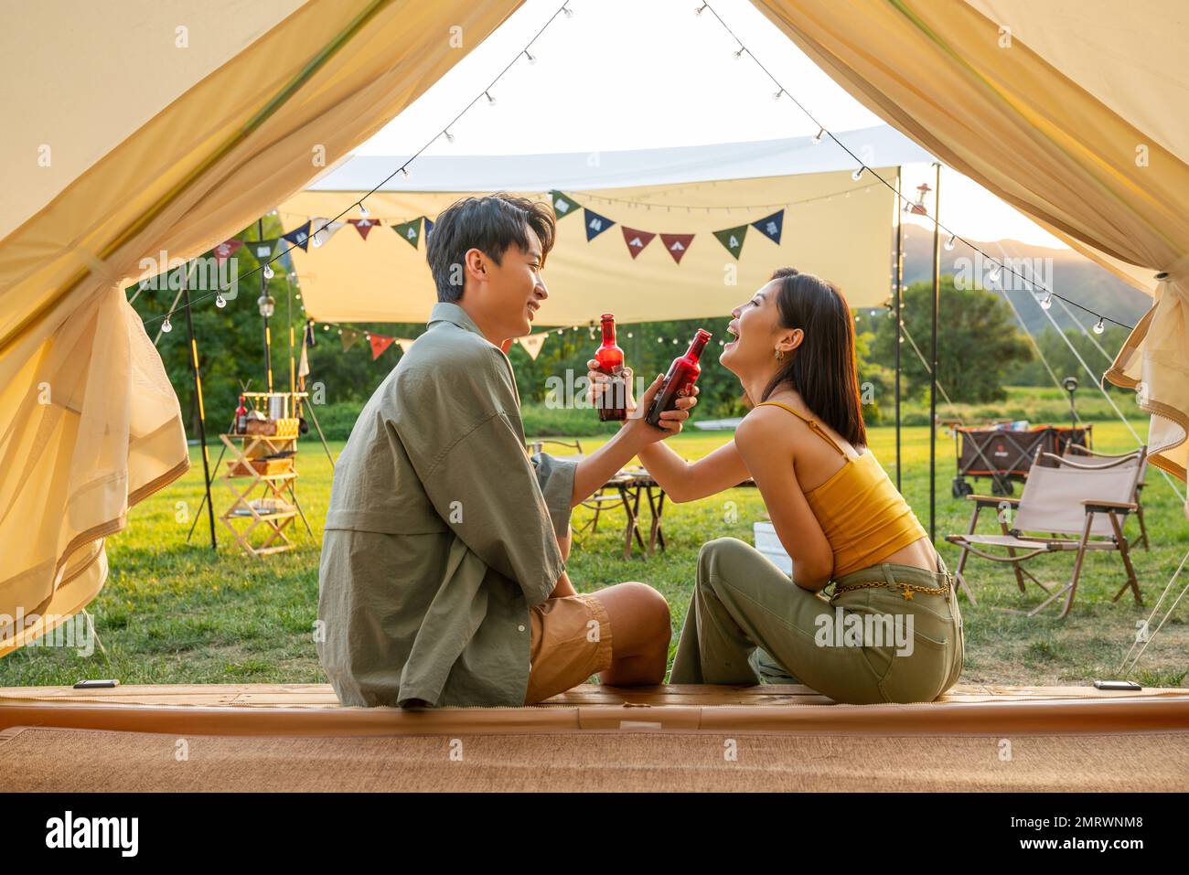 A group of people sat under the tent Stock Photo - Alamy
