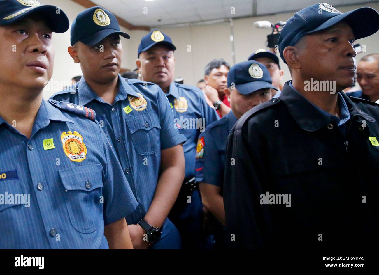 Police officers, PO1 Jeremias Pereda, second from left, PO3 Arnel Oares, right, and PO1 Jerwin ...