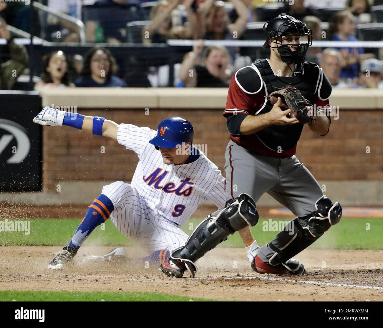 New York Mets' Brandon Nimmo (9) slides past Arizona Diamondbacks ...