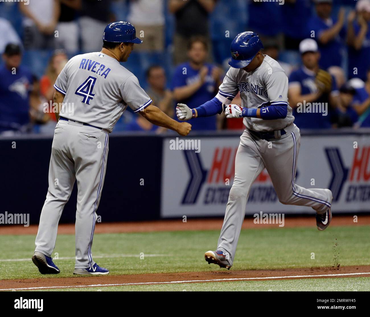 Toronto Blue Jays' Ryan Goins, right, celebrates his home run off Tampa ...