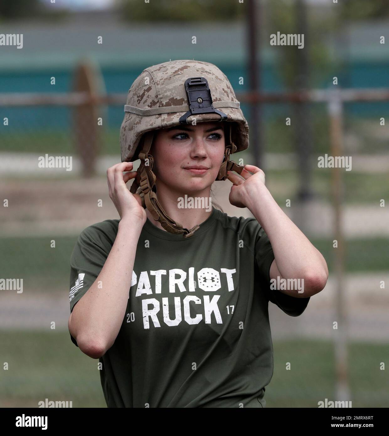 Model and actress Kate Upton puts on a Marine helmet after taking part ...